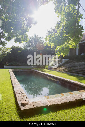 Sunny backyard with lap pool Stock Photo - Alamy