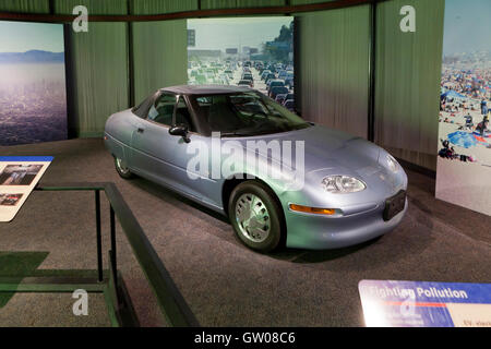 A General Motors EV1 electric car has its battery recharged at a ...