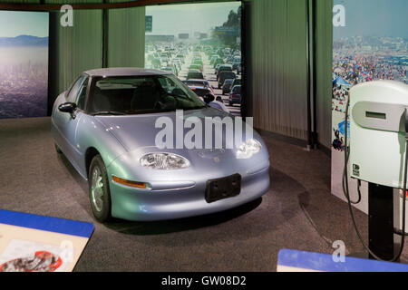 A General Motors EV1 electric car has its battery recharged at a Stock ...