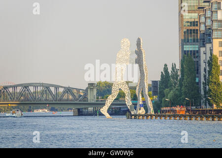 The huge Molecule Men Statue on River Spree in Berlin Stock Photo - Alamy
