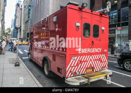 A Con Edison emergency repair red truck at a utility manhole in the ...
