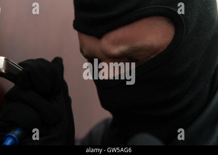 Thief Burglar Force Lock Metal Door With A Tool During House Breaking ...