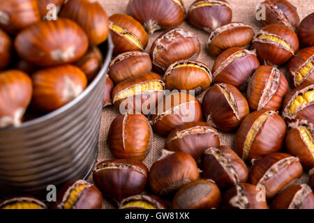 chestnuts in a tin bucket and chestnuts roasted on wood Stock Photo - Alamy