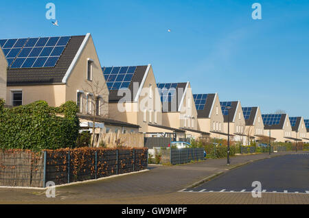Newly build houses with solar panels attached on the roof against a ...