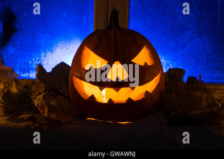 Angry face and scared face of Halloween pumpkins with tombstone on ...