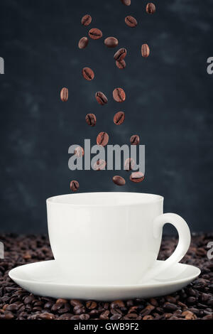 flying coffee beans with white cup Stock Photo - Alamy