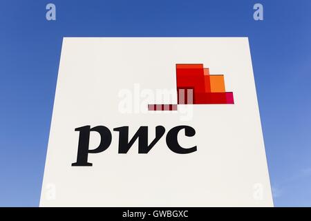 PwC logo sign on company office. PricewaterhouseCoopers is a ...