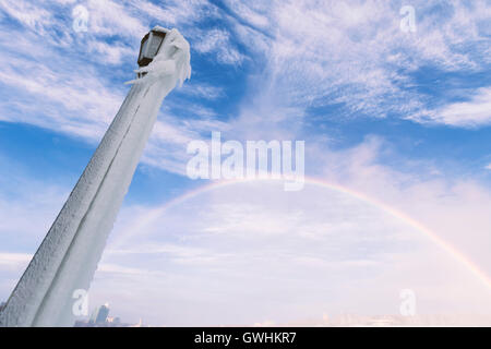Frozen lamp post with a rainbow Stock Photo - Alamy
