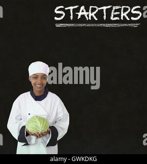 Chef with chalk starters sign on blackboard background Stock Photo - Alamy