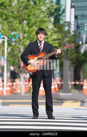 Young businessman employee playing guitar at workplace Stock Photo - Alamy
