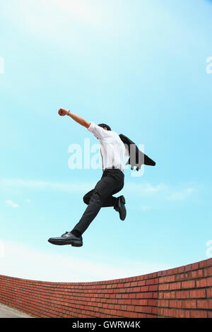 Young Japanese businessman jumping Stock Photo - Alamy