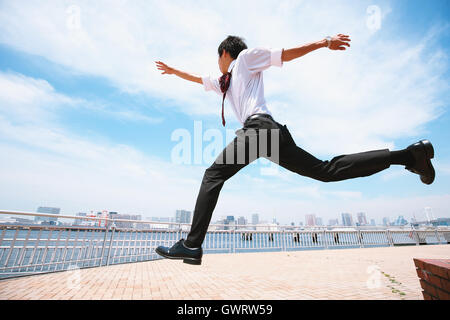 Young Japanese businessman jumping Stock Photo - Alamy