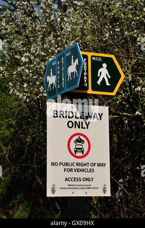Public bridleway sign for horse riders set against rural landscape with ...