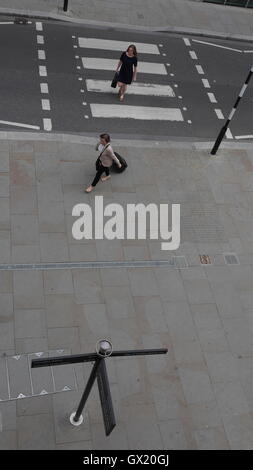 London signpost with pedestrians crossing a zebra crossing Stock Photo ...