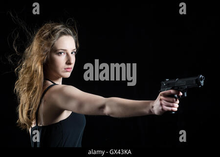 Action girl shooting guns, woman in red leather suit with hand weapons ...