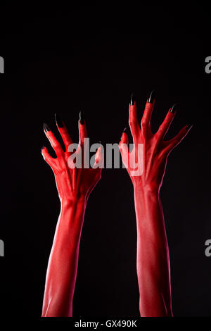Red demonic hands with black nails, Halloween theme, studio shot on ...