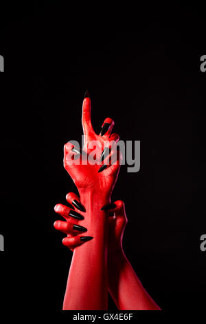 Red demonic hands with black nails, Halloween theme, studio shot on ...