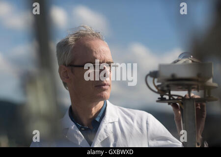 Male meteorologist monitoring meteorological equipment measurements at ...