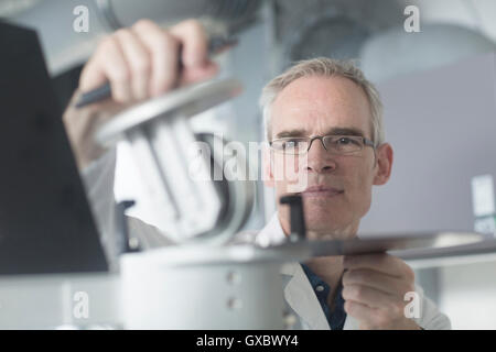 Male meteorologist preparing equipment in weather station laboratory ...