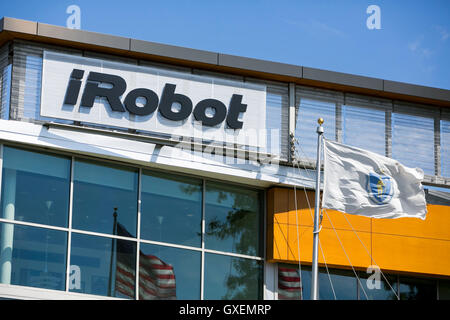 A logo sign outside of the headquarters of the iRobot Corporation in ...