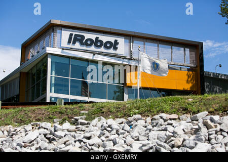 A logo sign outside of the headquarters of the iRobot Corporation in ...