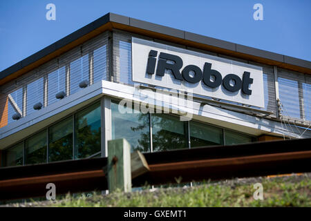 A logo sign outside of the headquarters of the iRobot Corporation in ...