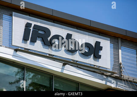 A logo sign outside of the headquarters of the iRobot Corporation in ...