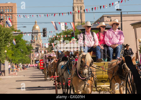 Cowboys riding in the Cheyenne Frontier Days parade past the state ...