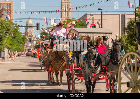 Cowboys riding during the Cheyenne Frontier Days parade past the state ...