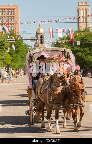 Cowboys riding during the Cheyenne Frontier Days parade past the state ...