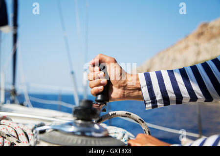 Young handsome sailor pulling rope on sailboat Stock Photo - Alamy