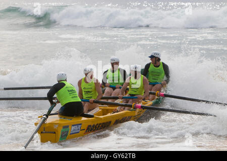 Traditional australian surf boat lifeguard rowing team off a Sydney ...