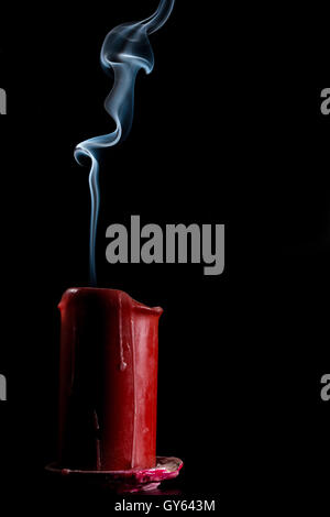 extinguished candle with blue smoke, black background Stock Photo - Alamy