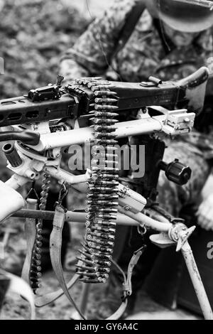 A machine gun clip of bullets loaded into a machine gun Stock Photo - Alamy