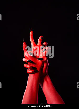 Red demonic hands with black nails, Halloween theme, studio shot on ...