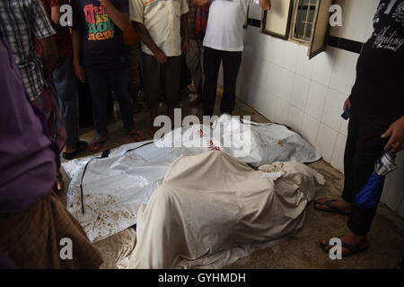 Bodies of a fire victims are placed at a makeshift morgue in a hospital ...