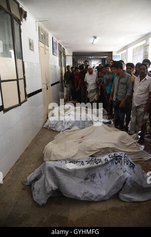 Bodies of a fire victims are placed at a makeshift morgue in a hospital ...