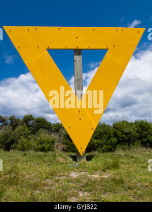 Shipping navigation yellow triangle sign on land Stock Photo - Alamy