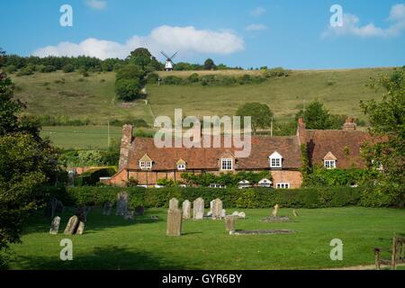 Turville Village showing the gravestones and Cobstone windmill in th ...