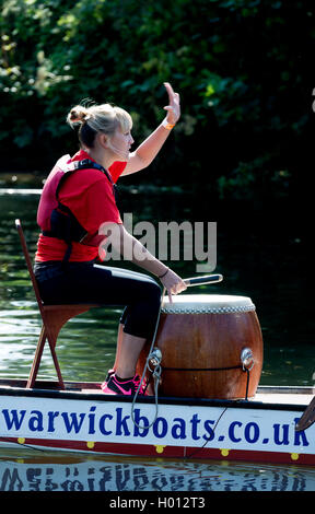 A female drummer on a Dragon Boat. The race was started by Dame Kelly ...