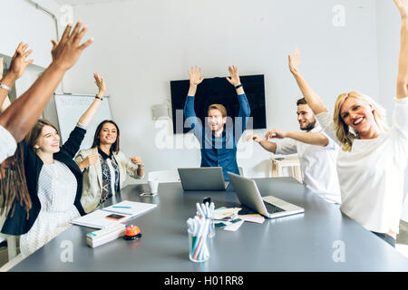 Happy colleagues are cheering after successfully completing task Stock ...