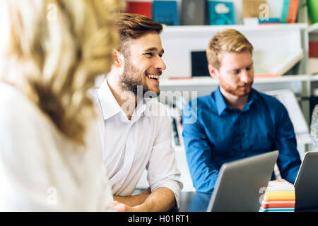 Cheerful coworkers in office during company meeting Stock Photo - Alamy