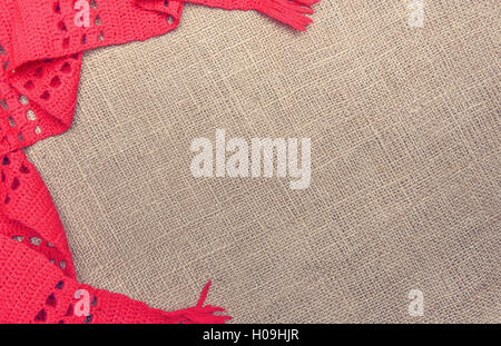 A red scarf on the background of burlap Stock Photo - Alamy