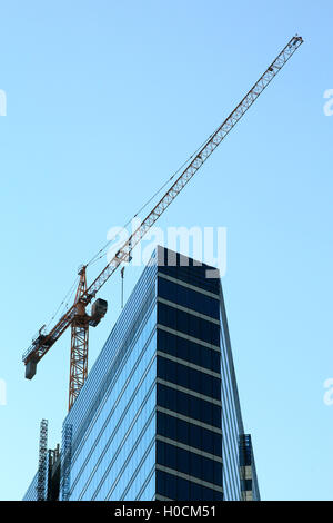 Modern high-rise building under construction with glass windows and ...