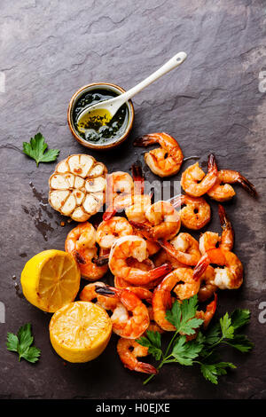 Prawns Shrimps roasted on pan with lemon and garlic. Black background ...