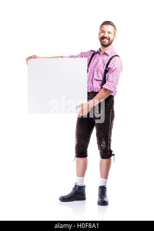 Handsome man in traditional German clothes and with beer on white ...