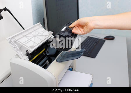 Male hand holding color printer toner Stock Photo - Alamy