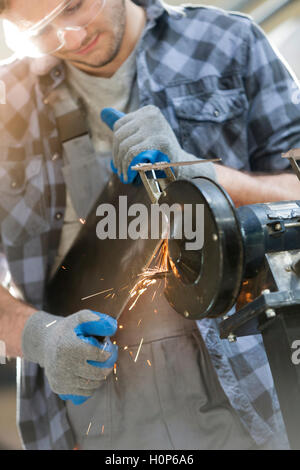 metal worker using sander workshop Stock Photo - Alamy