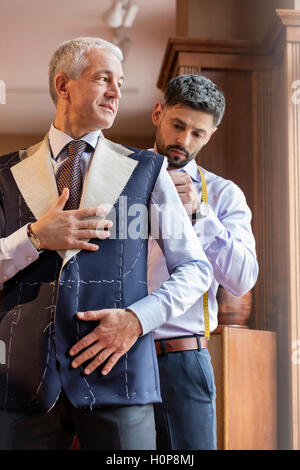 tailor fitting businessman suit menswear shop Stock Photo - Alamy