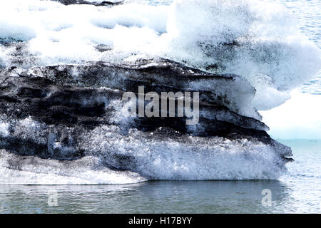 cross section of glacial ice with ash in iceberg Jokulsarlon glacial ...